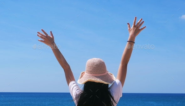 People from behind. People happy in summer time closeup blue sky ocean ...