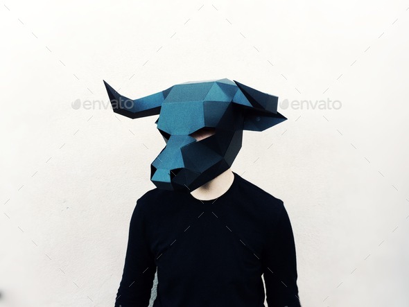Young millennial boy wearing low poly bull mask Stock Photo by dabobabo