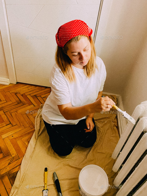 A girl painting the home radiator in white color Stock Photo by ...