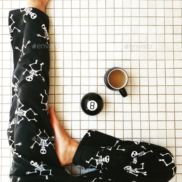 Lower section of person wearing pyjama pants with magic eight ball and ...