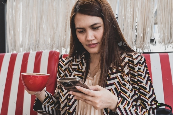 Women user smartphone and playing social media on the cafe Stock Photo ...