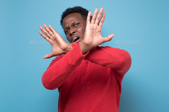 man showing refusal and denial with afraid and disgusting expression ...