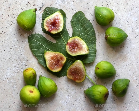 Freshly picked green figs on stone table with fig leaf Stock Photo by ...
