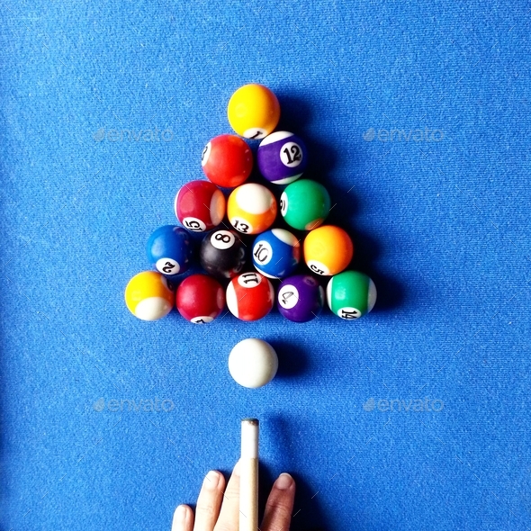 pool table game set on blue table with hand holding cue stick Stock ...