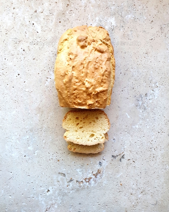 rustic style artisan loaf of bread sliced on stone table Stock Photo by ...