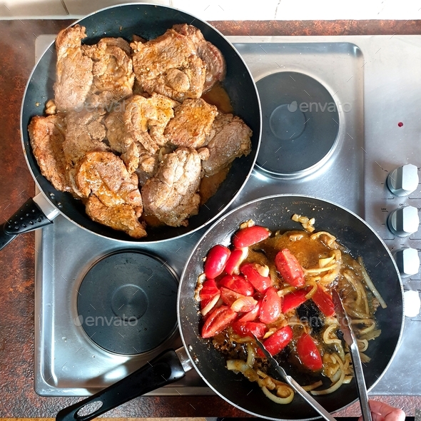 Overhead view of cooking food with two pans on electric stove top Stock ...