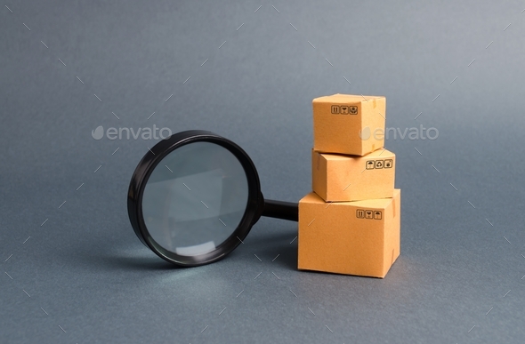 Cardboard boxes and a magnifying glass Stock Photo by iLixe48 | PhotoDune