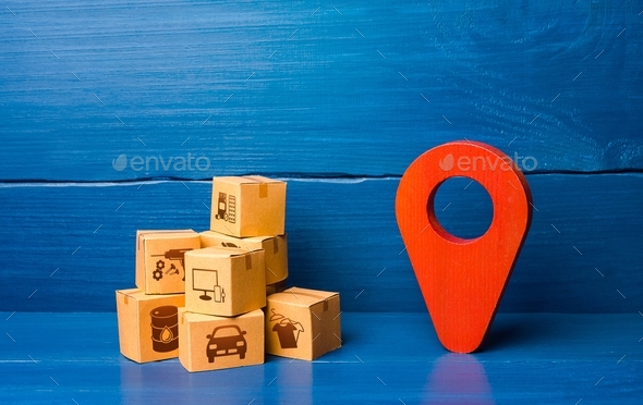 Red location pointer symbol and cardboard boxes Stock Photo by iLixe48
