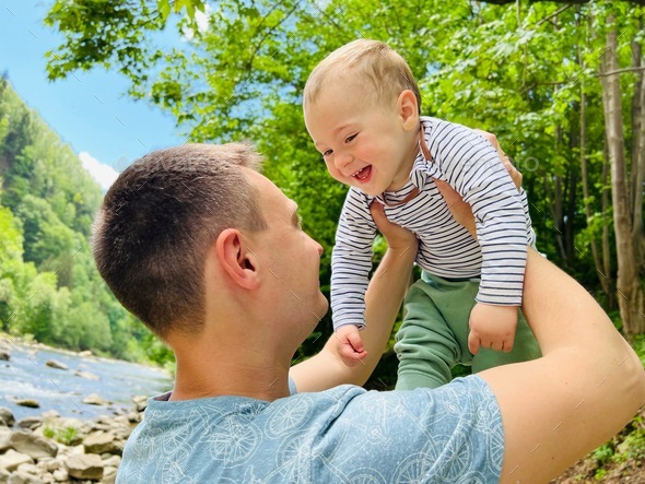 Nominated!A happy father raises his son above himself. Family concept ...