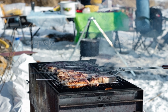 Winter barbecue party outdoors, grill steak meat over hot coals in BBQ ...