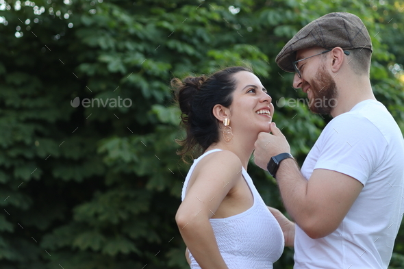 Couple of young lovers smiling each other with natural background Stock ...
