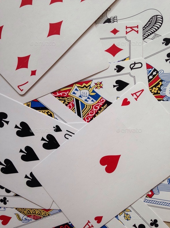 Playing cards scattered on a table. Stock Photo by bclare2 | PhotoDune