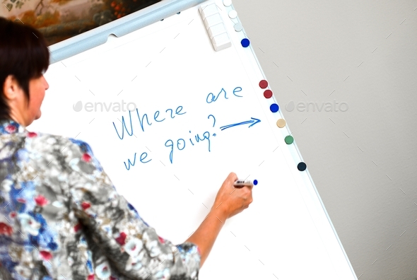 The woman writes a question on the whiteboard, where are we going ...