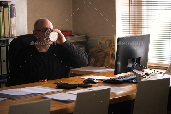 Man using computer and drinking coffee Stock Photo by zelmab | PhotoDune