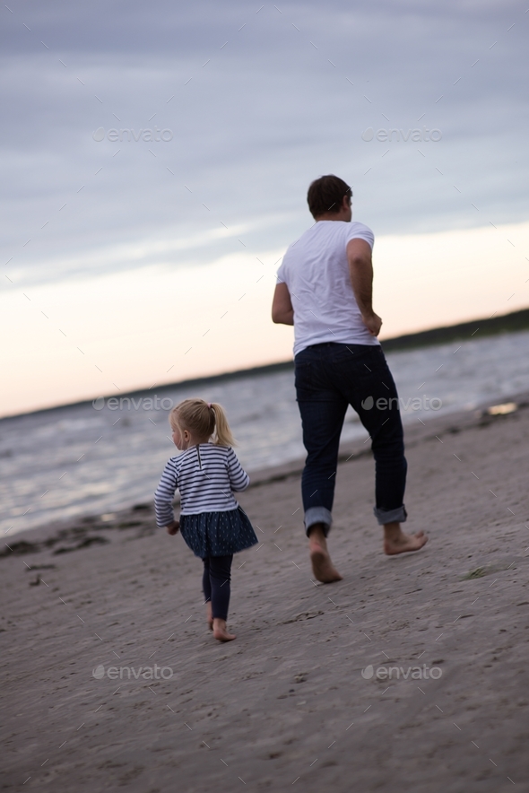 Father and daughter run along the sea....#NOMINATED! Stock Photo by zelmab