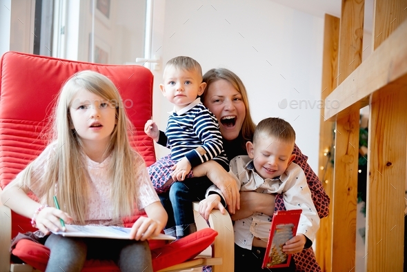 happy mother has a good time with her three children in the family ...