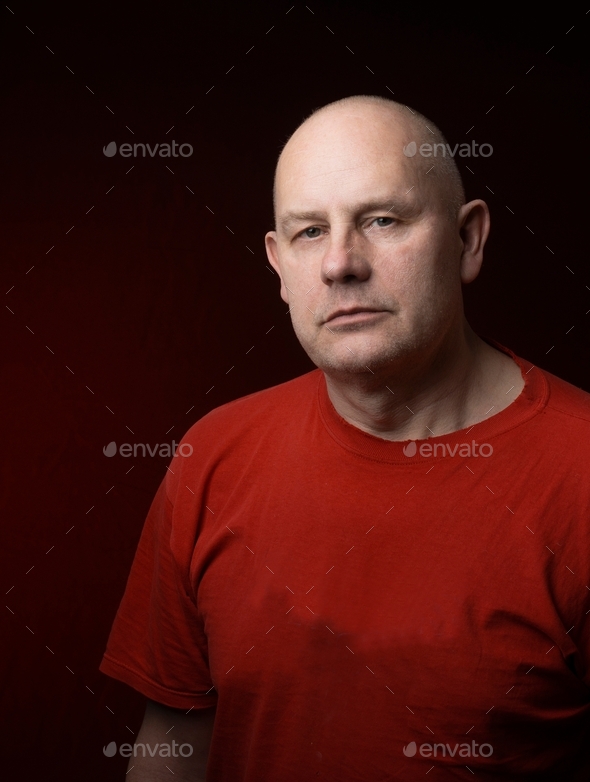 Studio portrait of middle-aged man serious face looking camera isolated ...