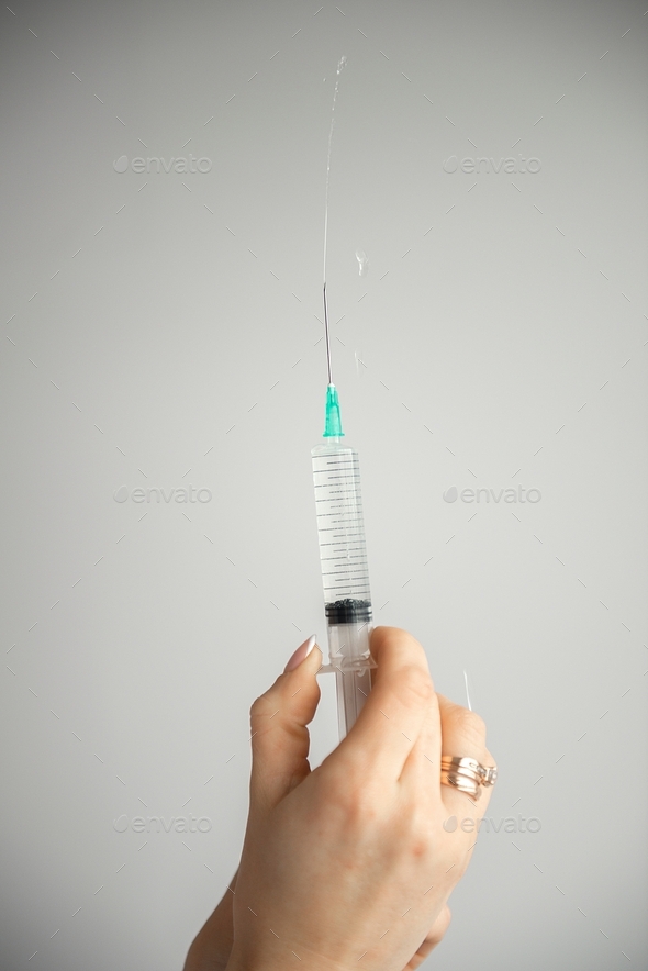 Syringe, medical injection in hand, palm or fingers. Medicine plastic ...
