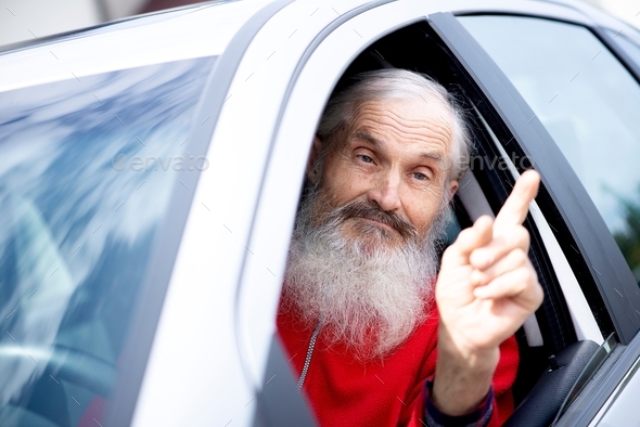 Retired elder senior man with long beard driving car Stock Photo by zelmab