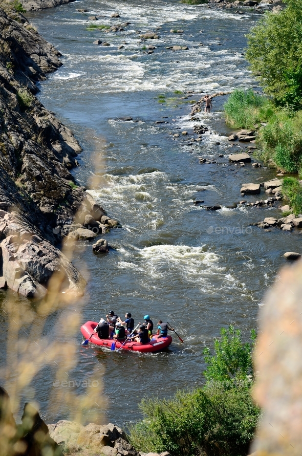 rafting on the river with rapids. a boat with people floats down the ...