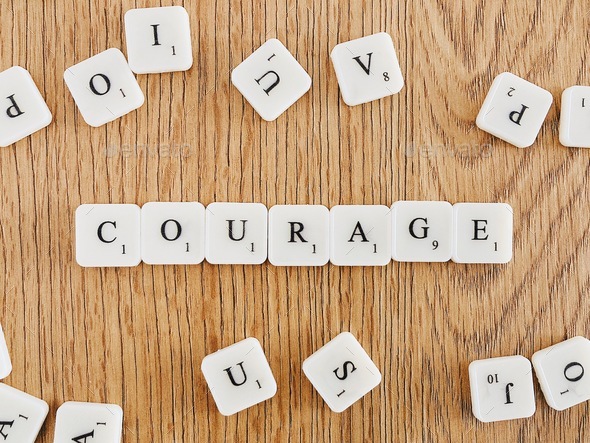 “Courage” written with scrabble tiles Stock Photo by alexandrazaza