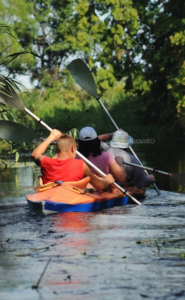 tourists are kayaking on a small river in summer Stock Photo by alexdov2