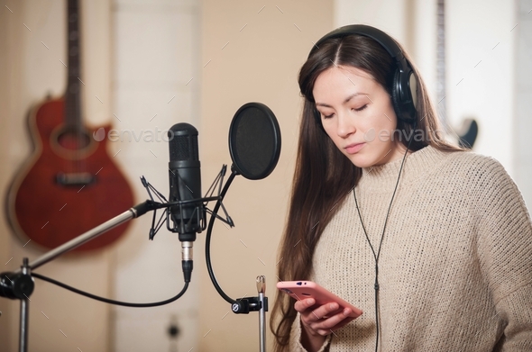 Young girl singer records vocals in professional recording studio Stock ...