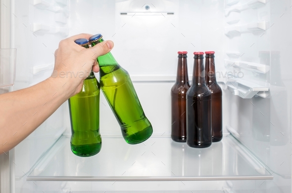Man taking a bottle of beer from the fridge close-up Stock Photo by ...