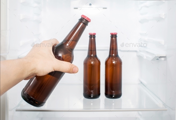 Man taking a bottle of beer from the fridge close-up Stock Photo by ...