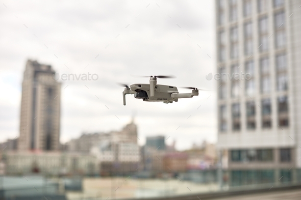 drone fly in city center. exploring new building with innovative ...