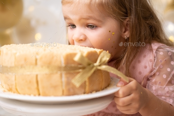 cute little child girl eating birthday cake without hand and ...