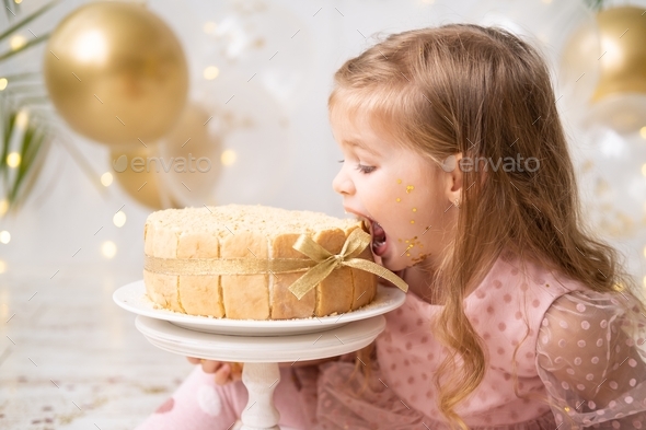cute little child girl eating birthday cake without hand and ...