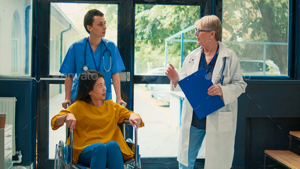 Nurse supporting asian woman with physical disability Stock Photo by DC ...
