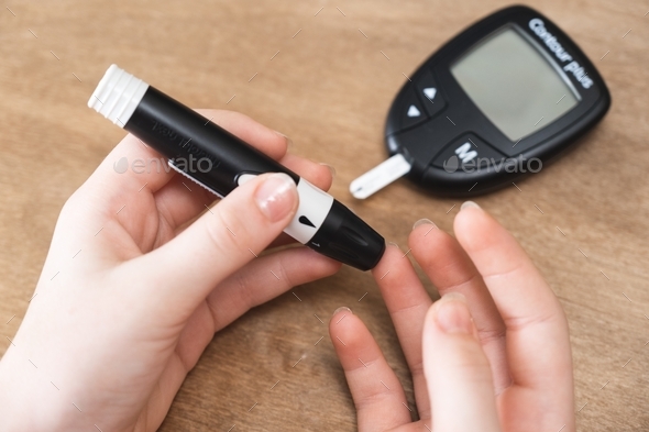 Child Hands Using Lancet on Finger to Check Blood Sugar Level by ...
