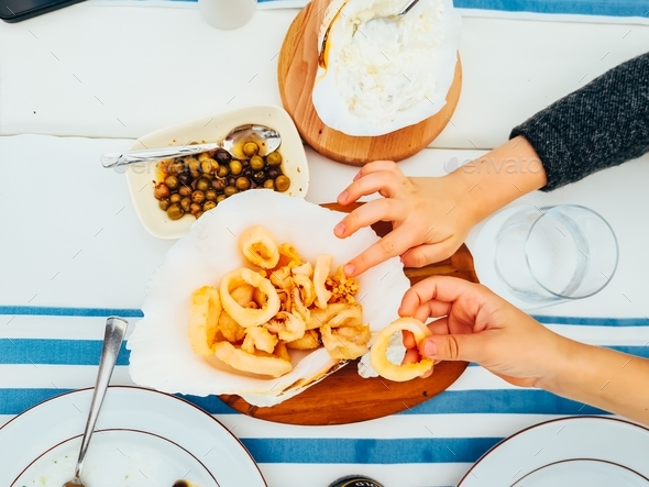 Kids eating fried calamaries in restaurant Stock Photo by ErMarca ...