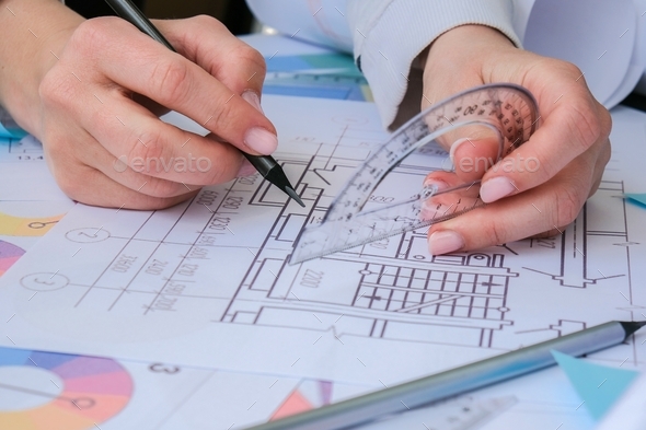 Hands use pencil with a protractor. Architectural Project drawings with ...