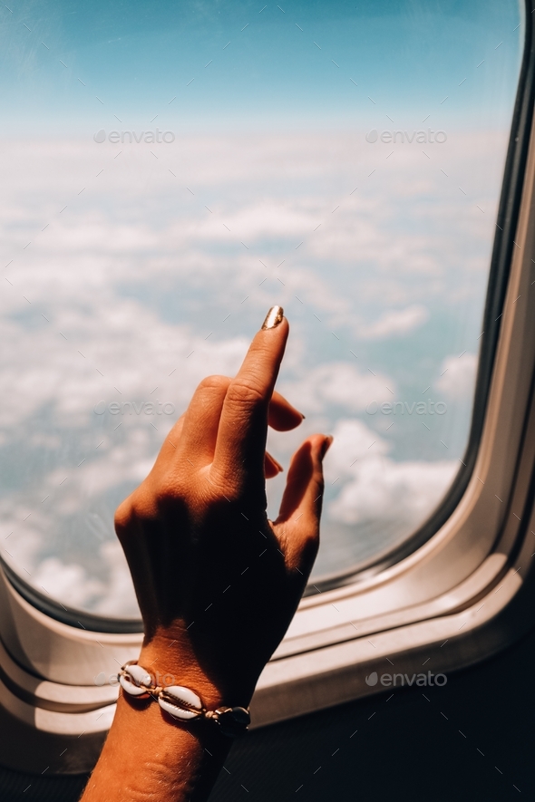Female hand Airplane flight. View from the window of the plane ...