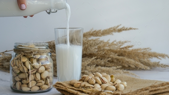 Vegetable milk is poured into a glass Pistachio lactose free milk for ...