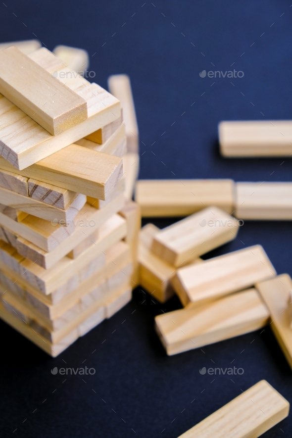 Building from wooden blocks. Game for family of wooden bars. Wood blocks stack game with Hand ...