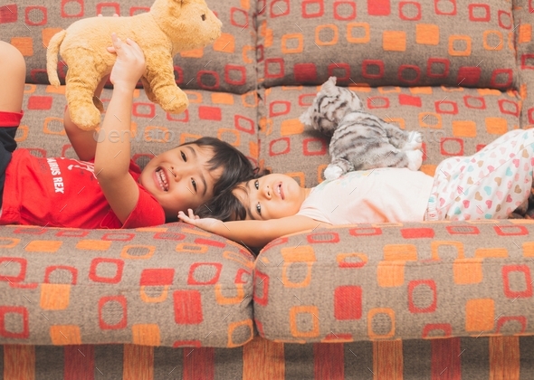 Kids playing on the couch Stock Photo by nazmanm | PhotoDune