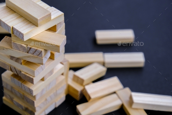 Building from wooden blocks. Game for family of wooden bars. Wood blocks stack game with Hand ...