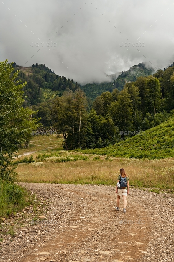 Take a hike, Young woman hiker back view with backpack walking on ...