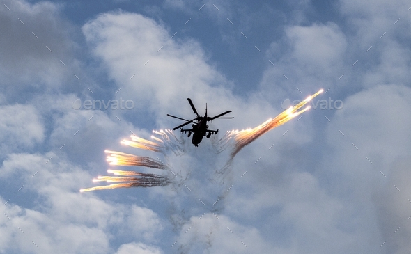 Combat military helicopter released heat traps Stock Photo by Lu_Igor