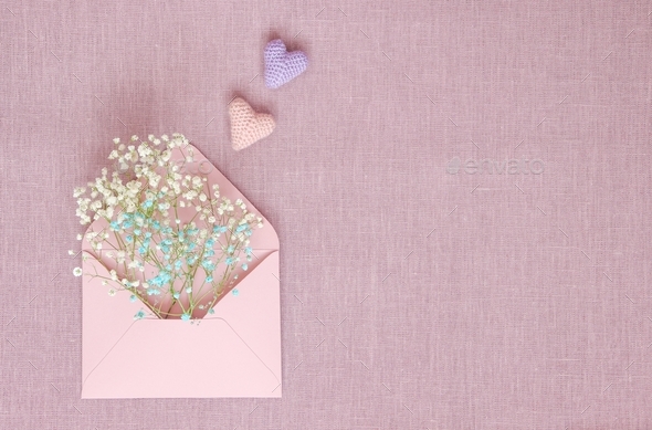 Pink envelopes for cards with wishes, white flowers and hearts on a ...