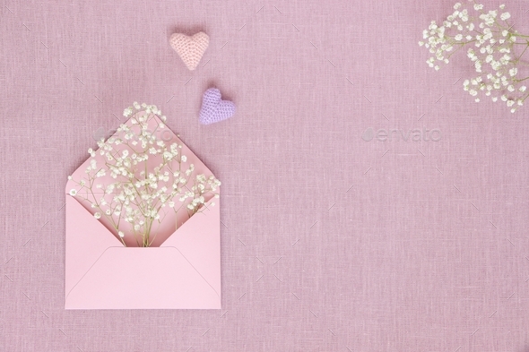 Pink envelopes for cards with wishes, white flowers and hearts on a ...