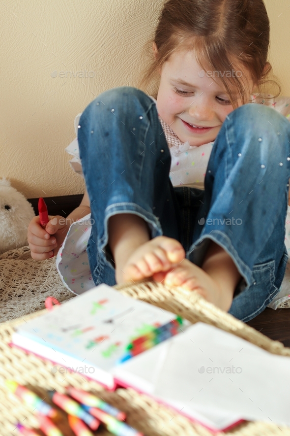 A little girl 6 years old is resting and thinking about a plot for ...