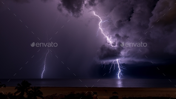 At night, two bright streaks of lightning hit the ocean of the Gulf ...