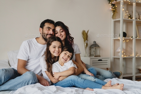 Happy family hugging in bed. Stock Photo by Ablozhka | PhotoDune