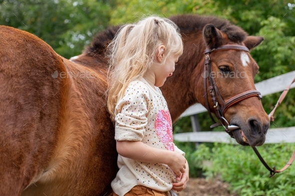 Girl and horse best friends in horse corral at ranch Stock Photo by ...