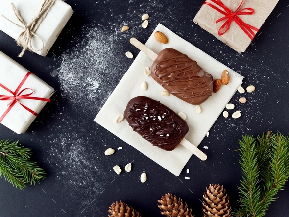 Flat lay eskimo biscuit cakes on a stick in dark and milk chocolate, in ...